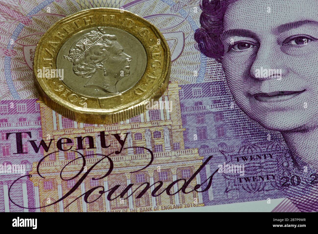 British one pound coin on the new £20 polymer banknote Stock Photo - Alamy