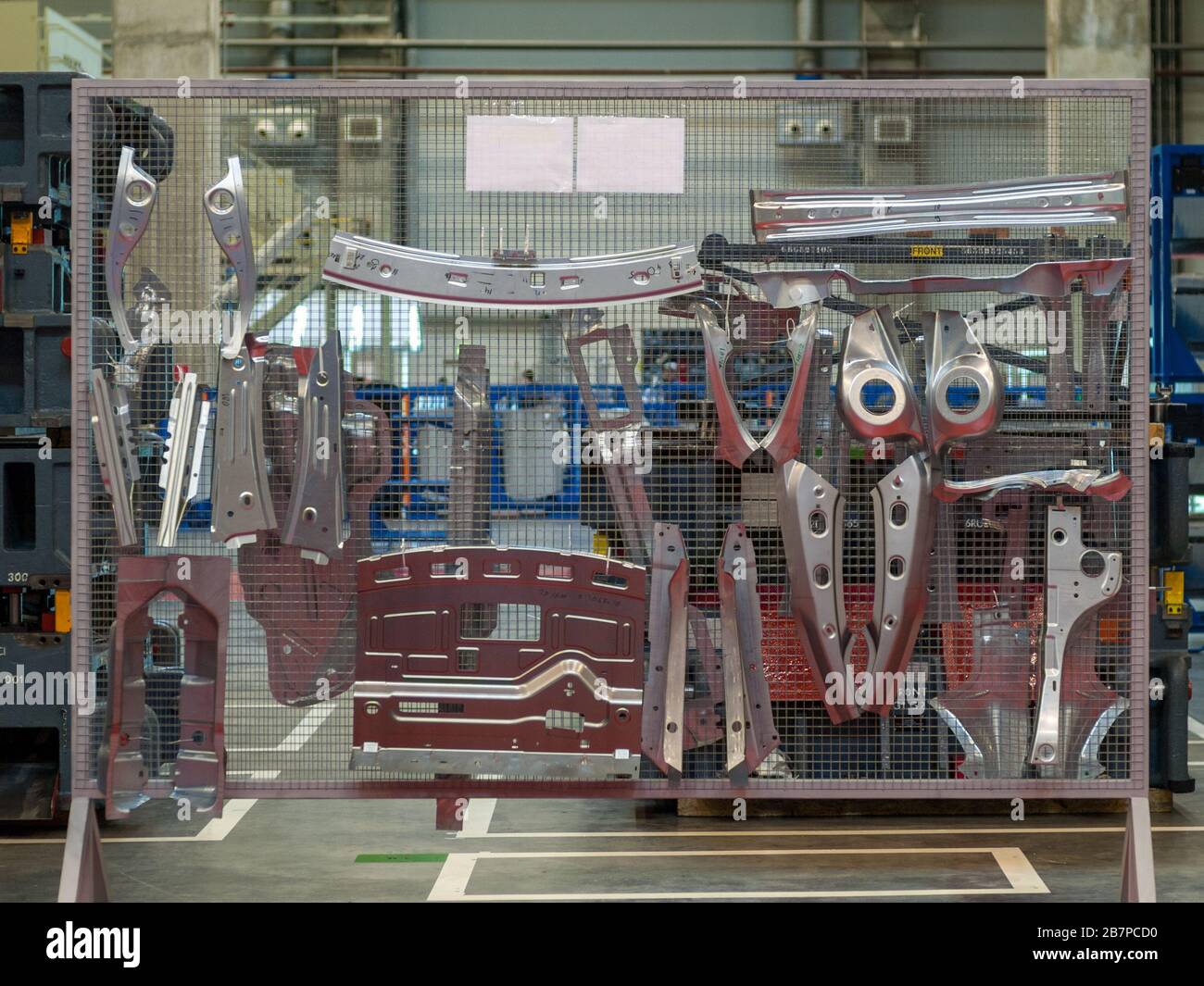 automotive industrial sheet metal formed parts on steel grid in ...