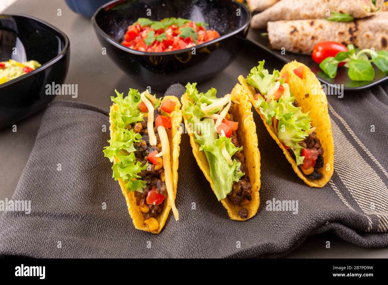 Three fresh tacos with beef, corn, tomatoes and lettuce. Mexican ...