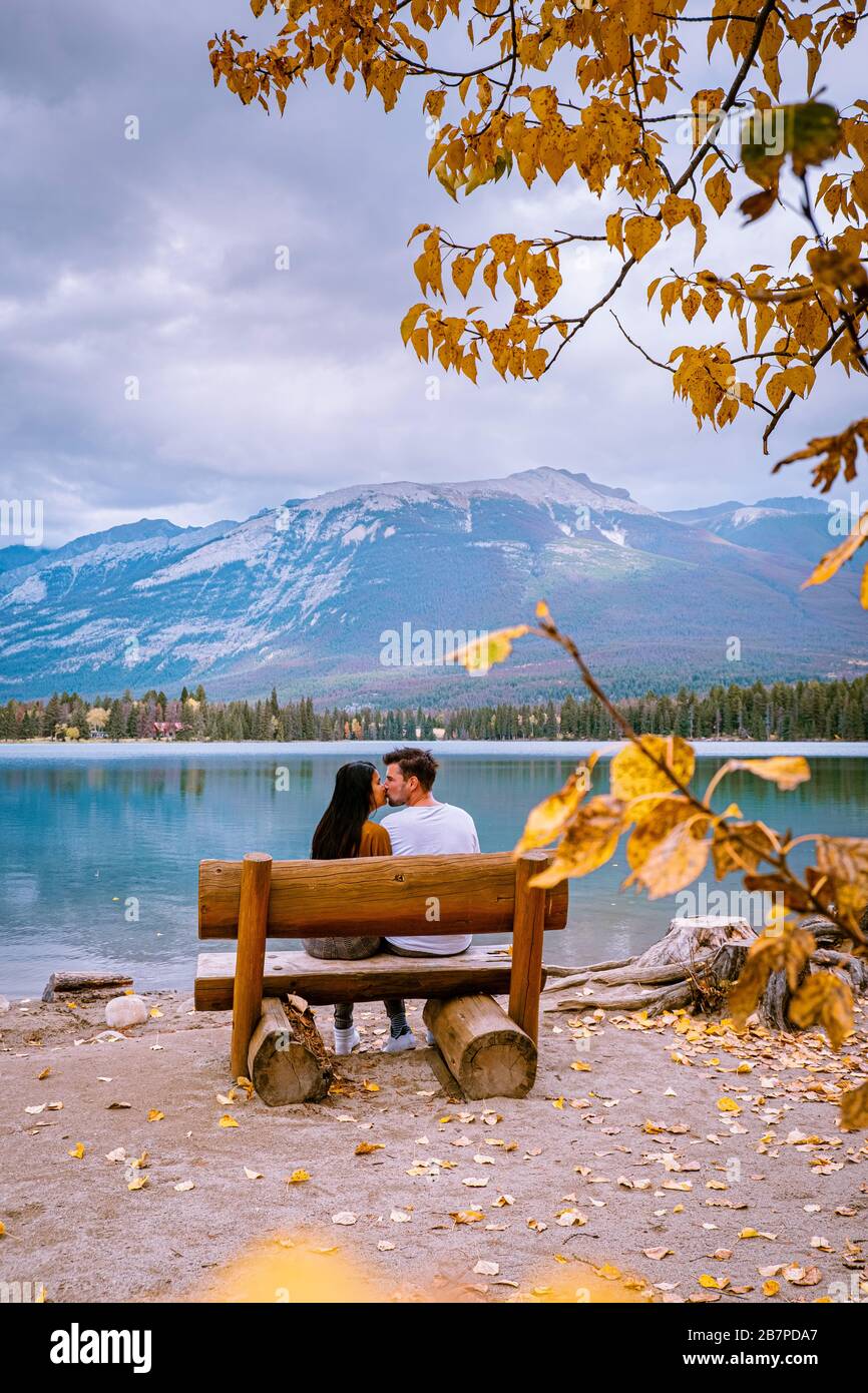 Jasper town Canada, couple at lakeshore, sunrise by the lake at Jasper ...