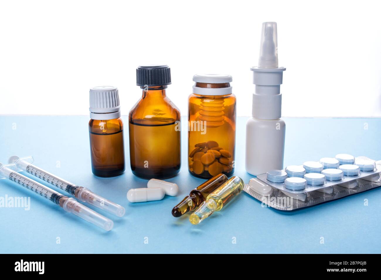 Tablets, pack of medicines with medicine bottles on a blue background ...