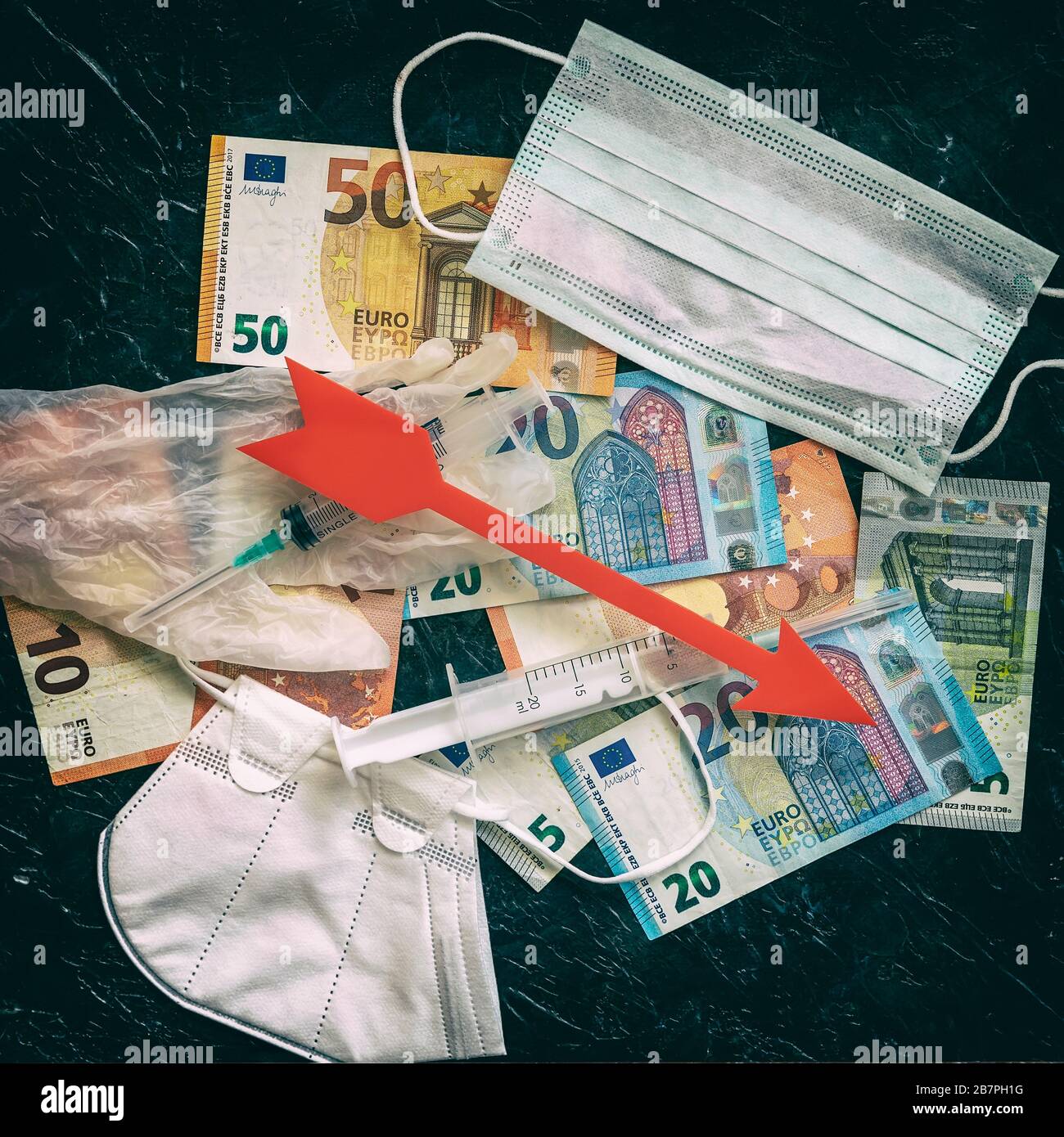 Euro banknotes and red arrow symbol, disposable face mask, syringes ...