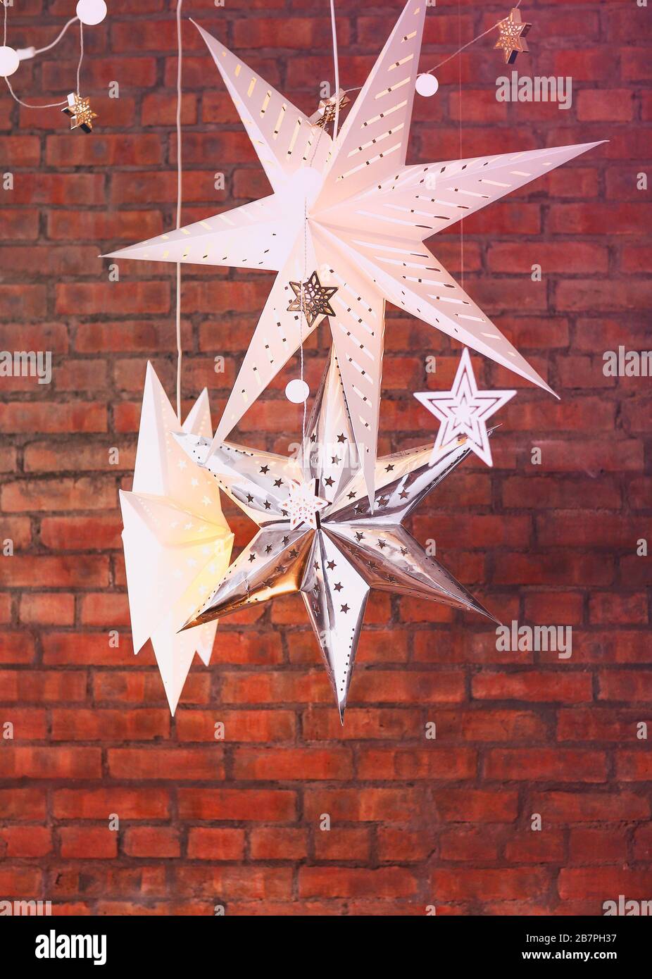 White decorative Christmas stars of various sizes and shapes hanging ...