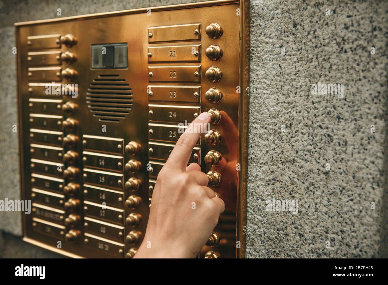 Female hand presses the intercom button to access inside Stock Photo ...