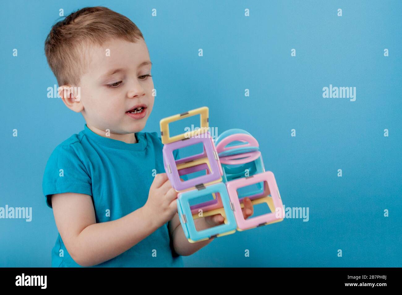 Boy looks through the shape in the color constructor with the ...