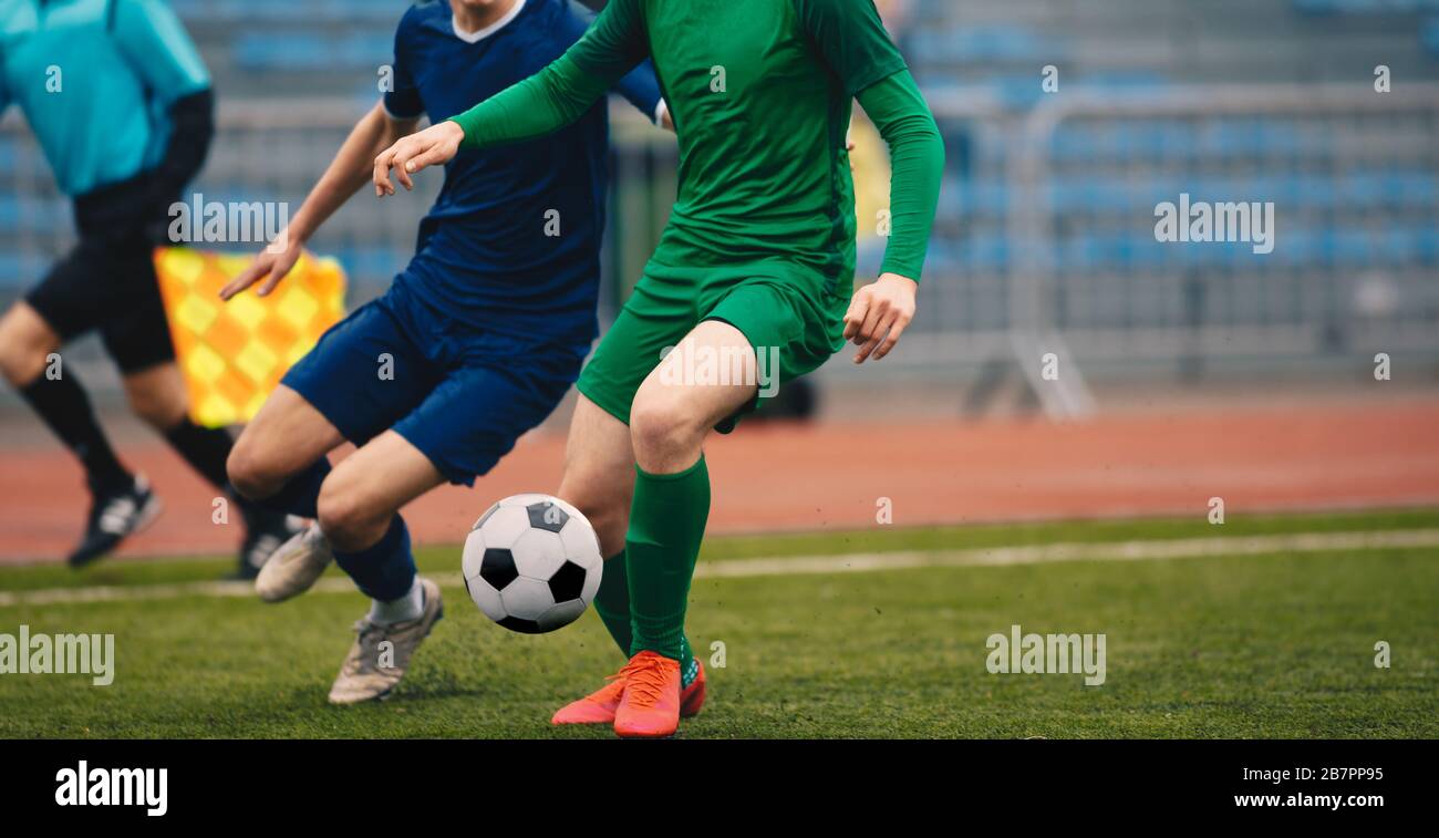 Soccer football players competing for ball and kick ball during match ...