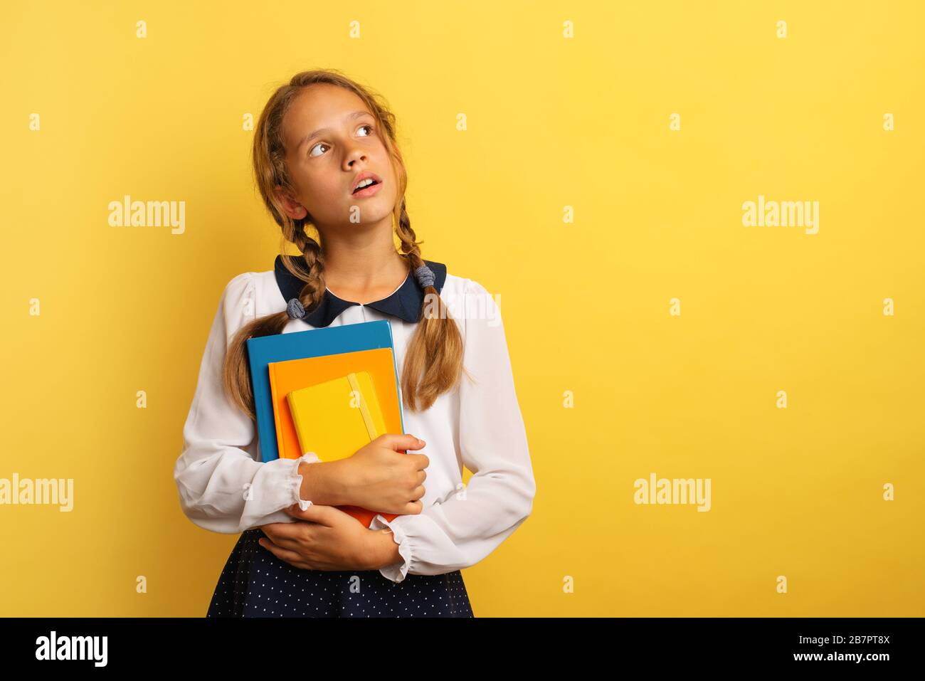 Young student watch something with wondered expression. Yellow ...