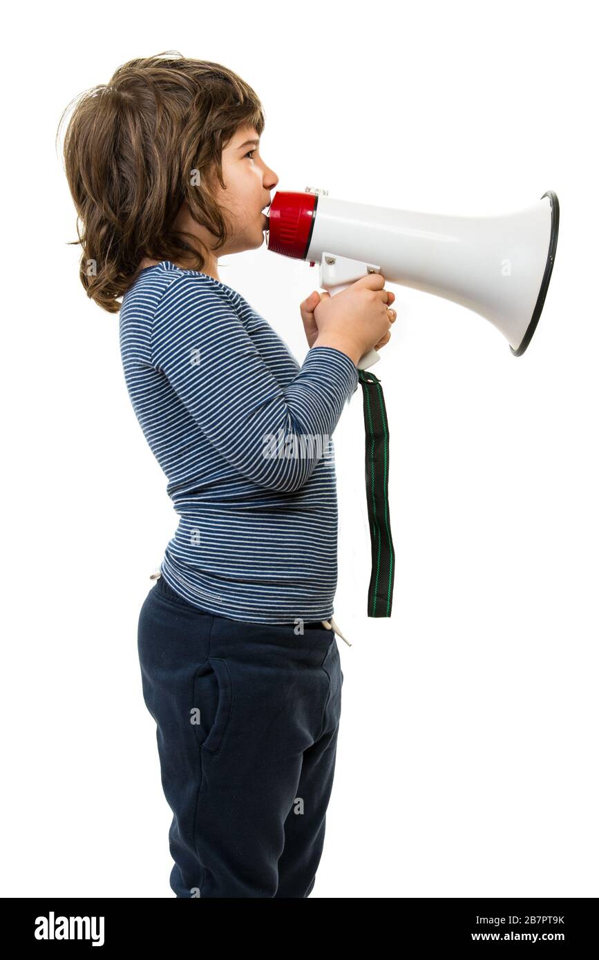 Boy standing in profile and speaking by megaphone isolated on white ...