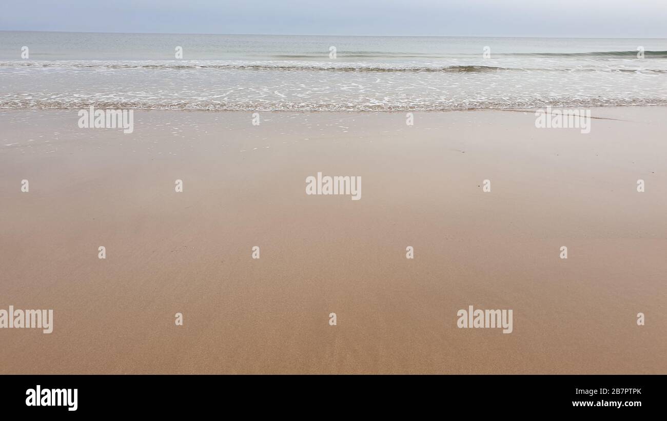 Waves breaking on beach Stock Photo - Alamy