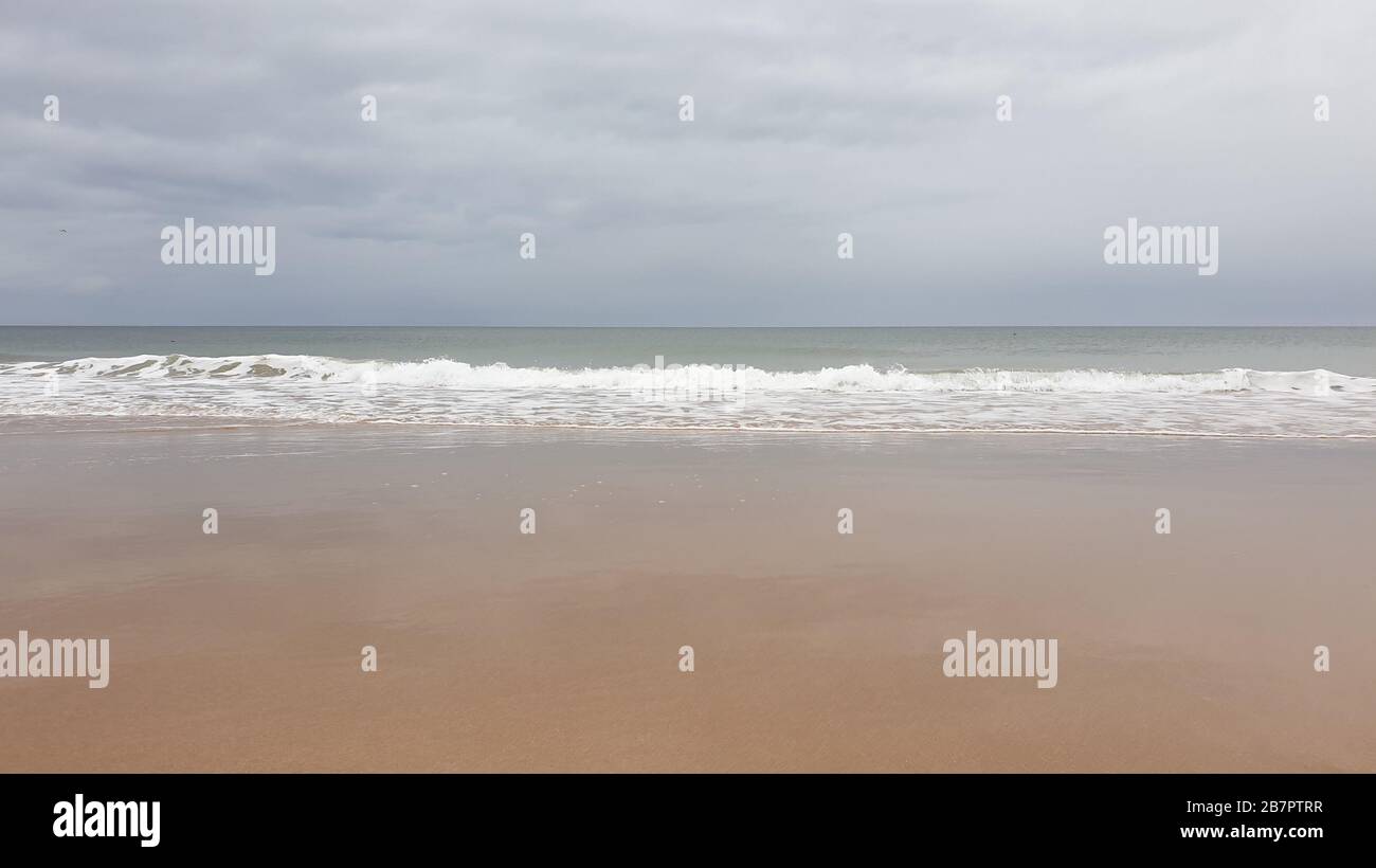 Waves breaking on beach Stock Photo - Alamy