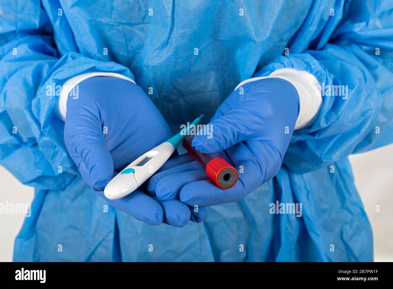 Close up medical surgeon holding digital thermometer and blood sample ...