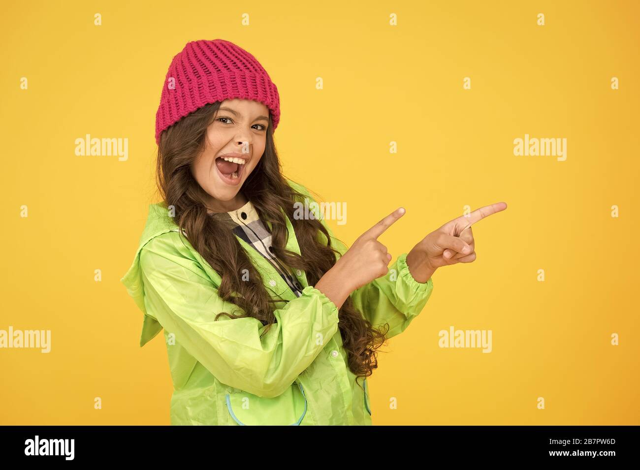 Best buy. Little girl point fingers at something yellow background ...
