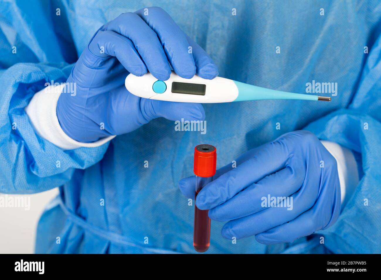 Close up medical surgeon holding digital thermometer and blood sample ...
