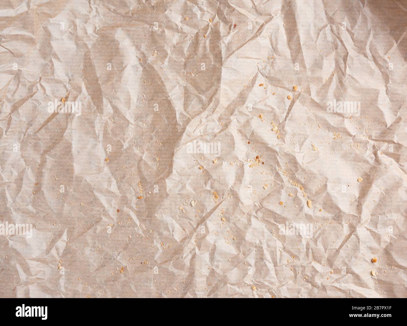 crumpled brown parchment paper with bread crumbs, full frame Stock ...