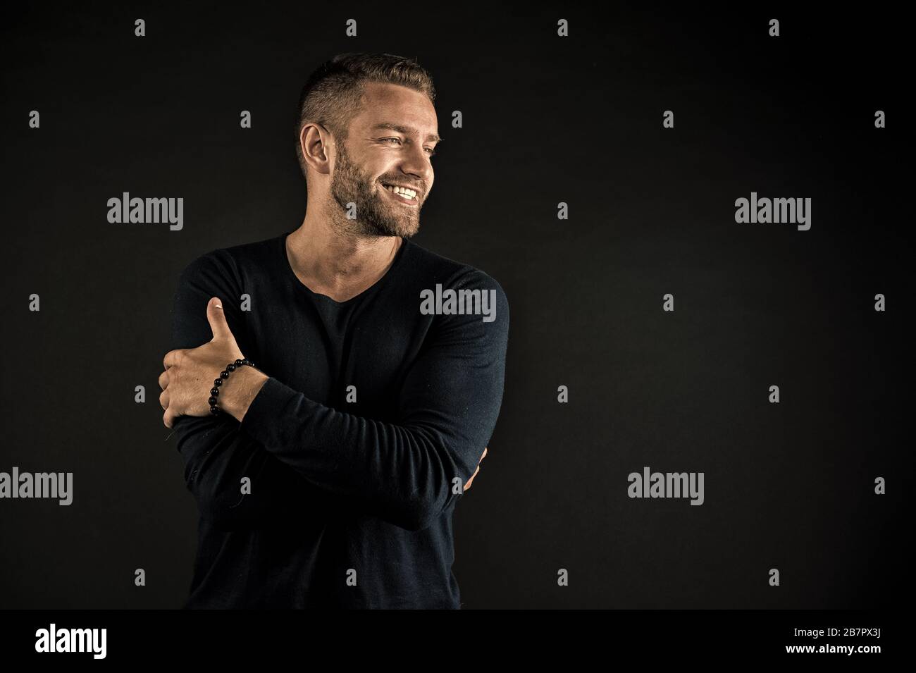 Man with happy unshaven face in studio. Fashion model on black ...