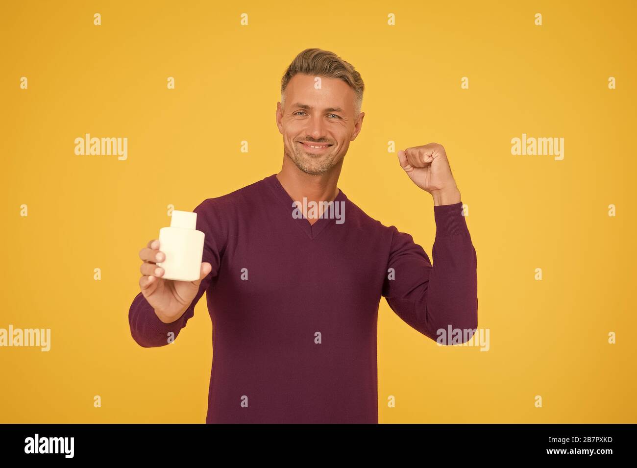 Smell good all day. Happy guy hold cologne bottle. Personal hygiene ...