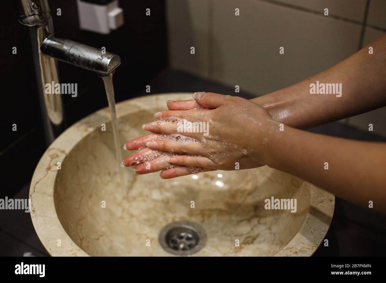 Hand washing in public bathroom hi-res stock photography and images - Alamy