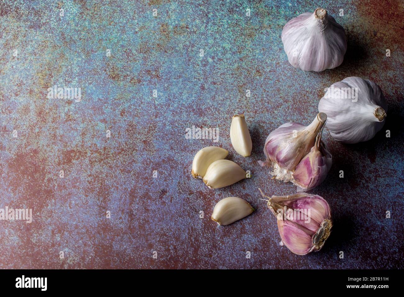 Fresh garlic cloves and bulb on colour background Stock Photo - Alamy