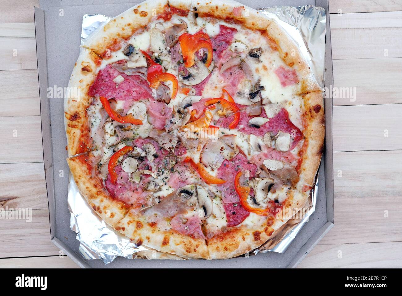 Pizza with salami, mushrooms, pepper and mozzarella. Circular pizza ...