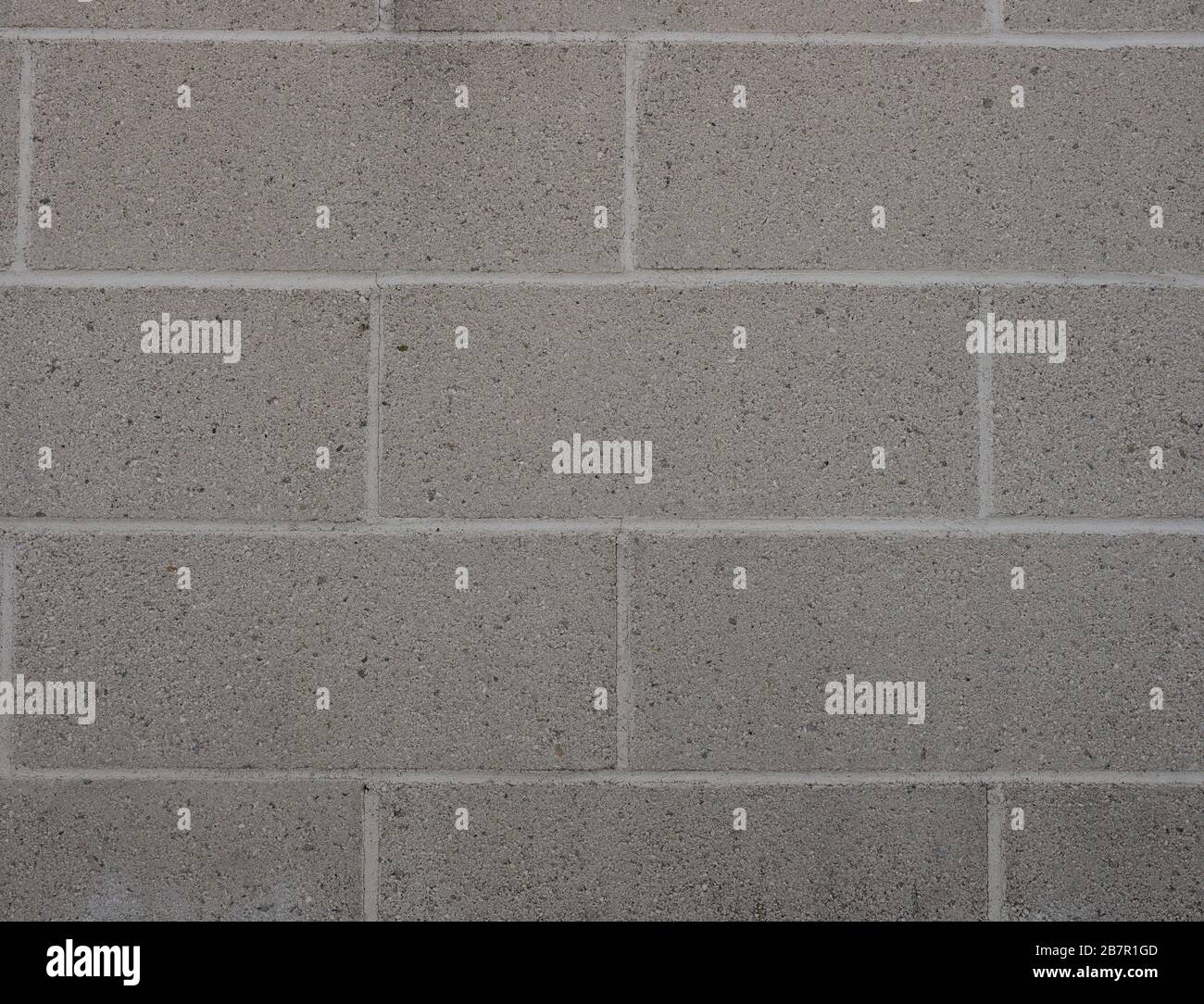 grey concrete brick wall useful as a background Stock Photo - Alamy