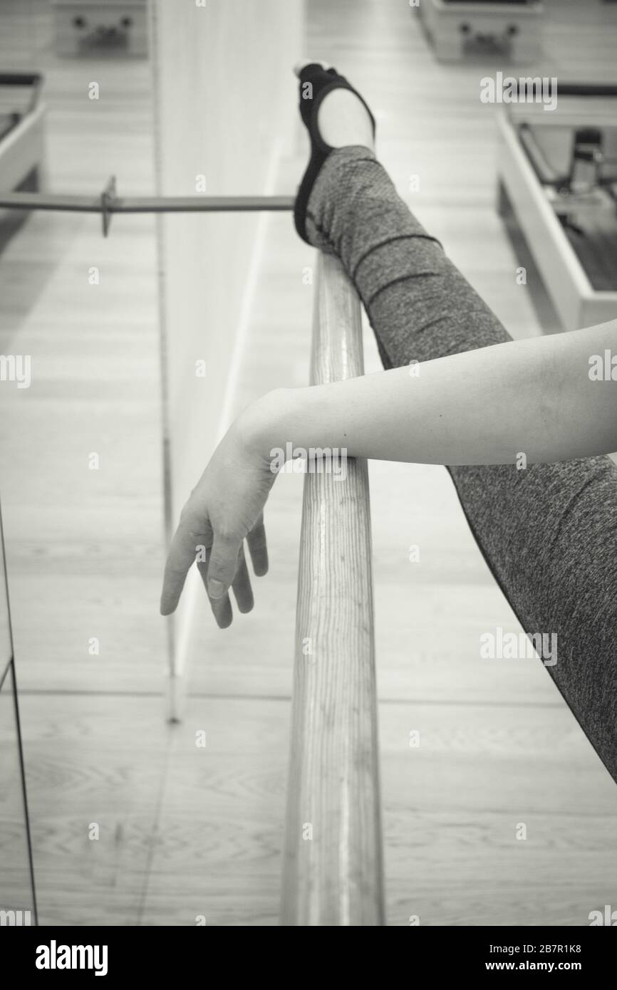 Female dancer doing leg stretches on the ballet barre Stock Photo - Alamy