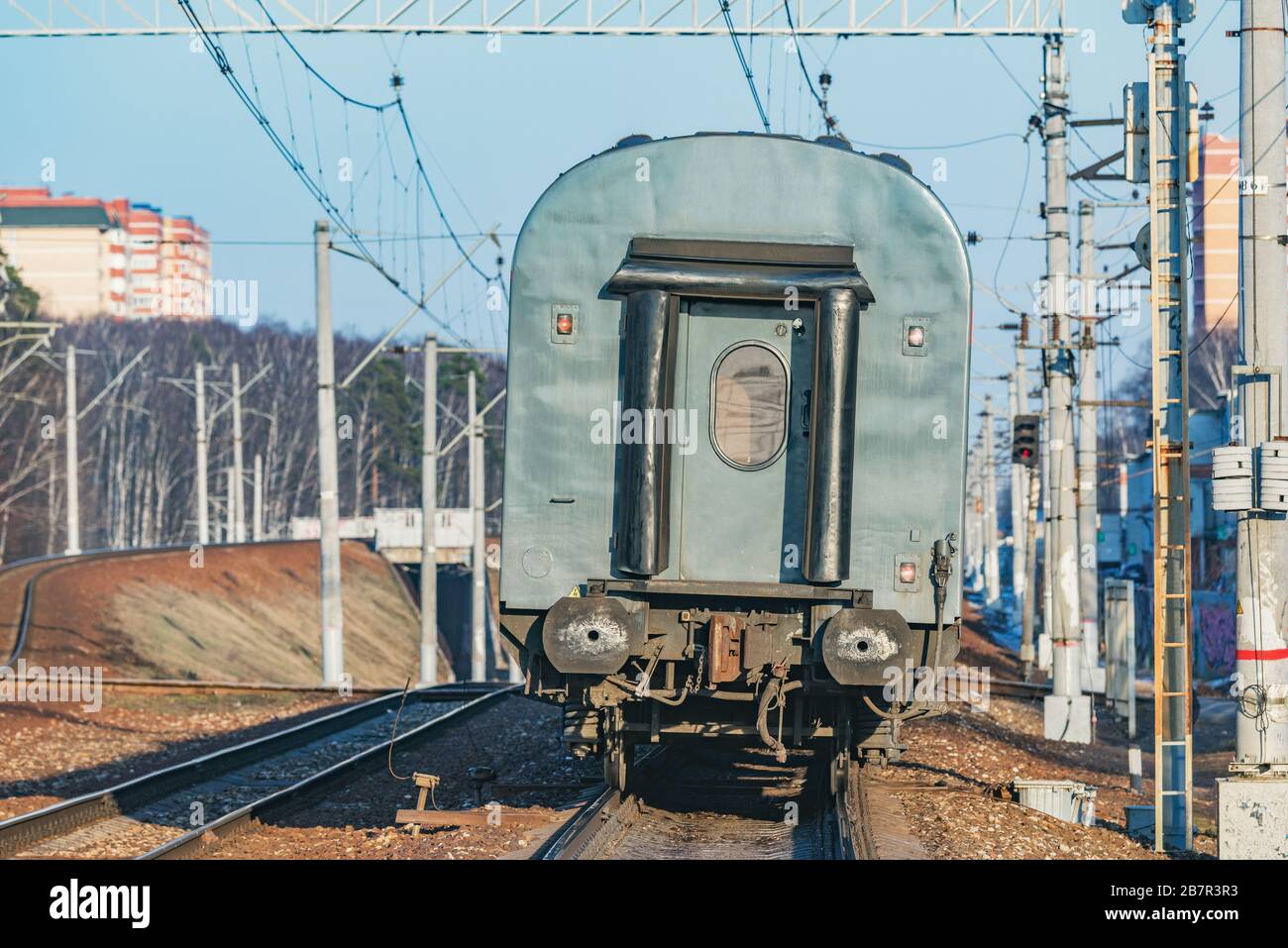 Last carriage of the passenger train approaching to the station Stock ...