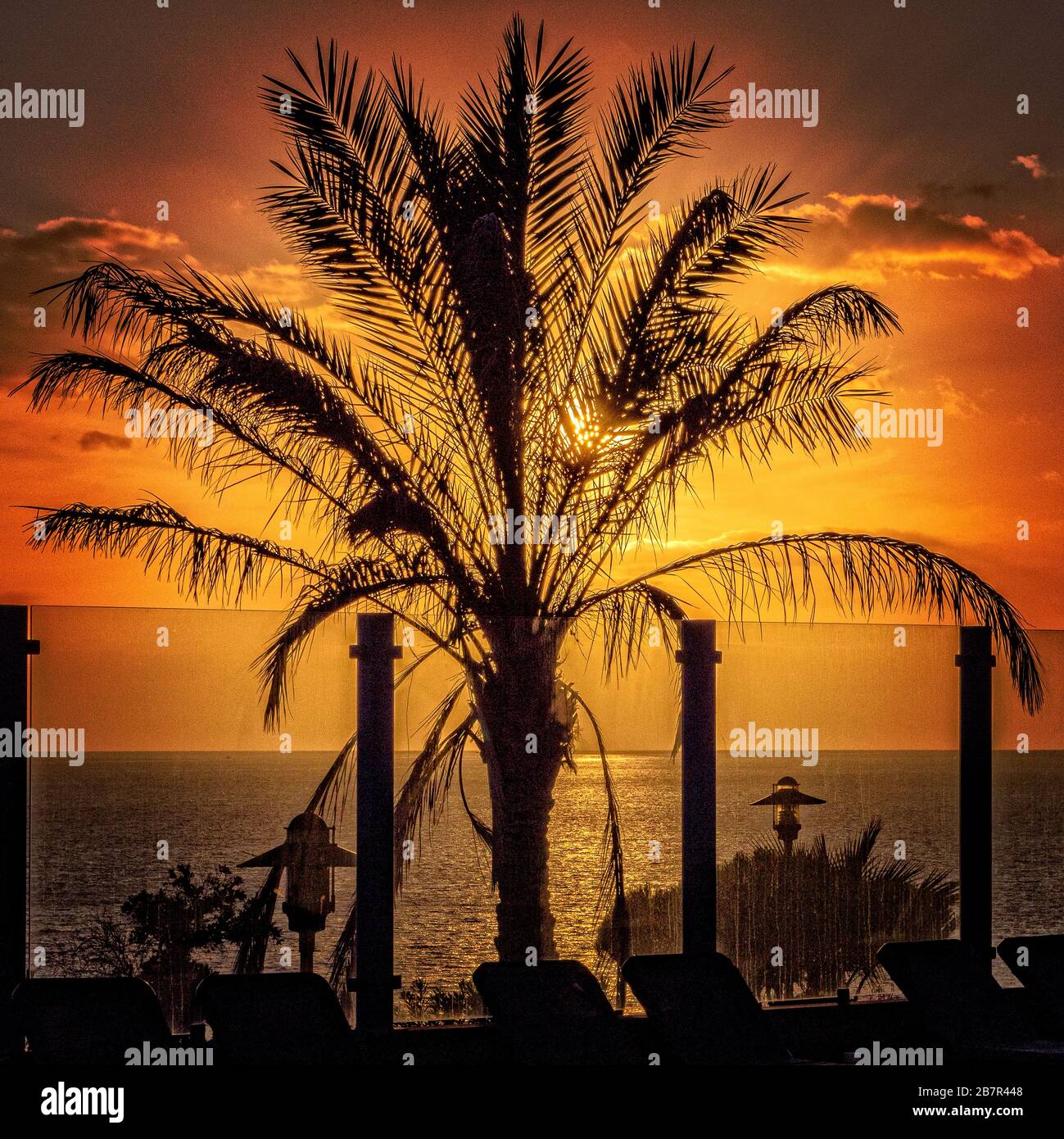Orange sun over tropical sea Stock Photo - Alamy