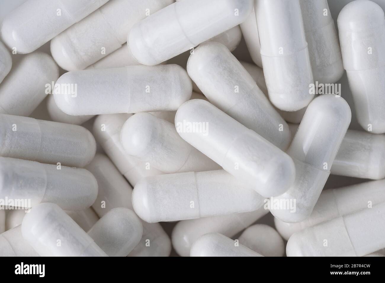 Top view Closeup pile of white antibiotic capsule pills texture ...