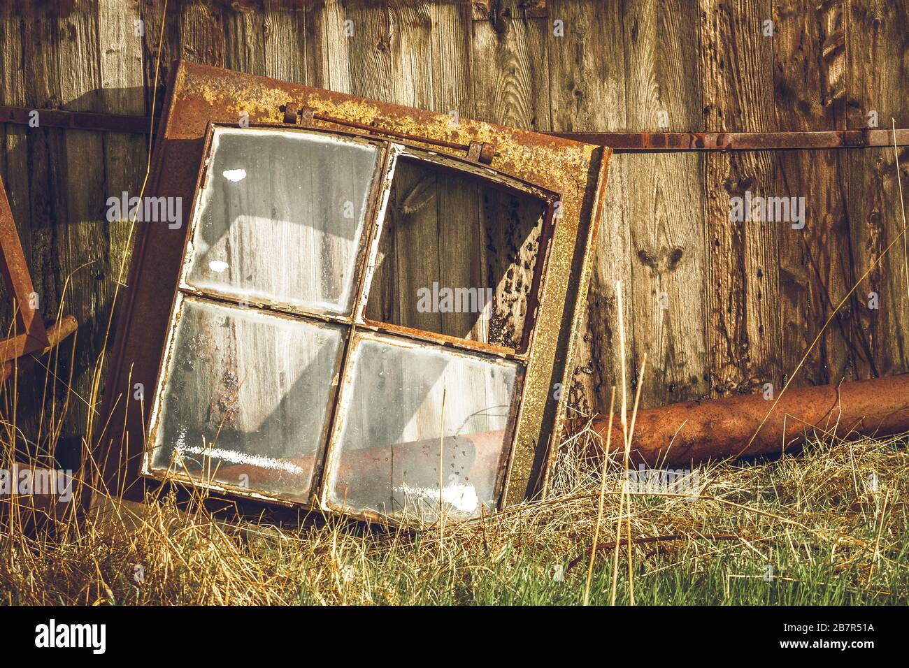 Old rusty and neglected window frame with only three of four window ...
