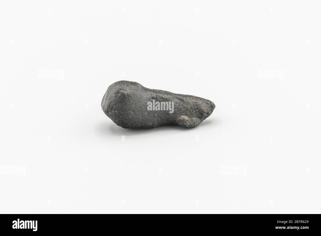 Black magnetic Atacaimite Tektite Meteorite isolated, a rock formed in ...