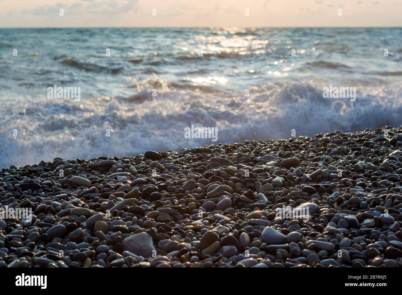 sea landscape is a pebbly beach with waves in white foam Stock Photo ...