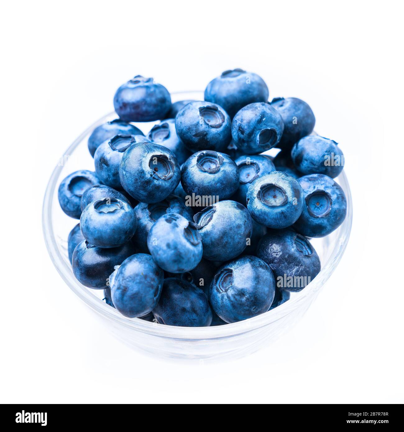 Blue berries in a glass cup, isolated on white Stock Photo - Alamy