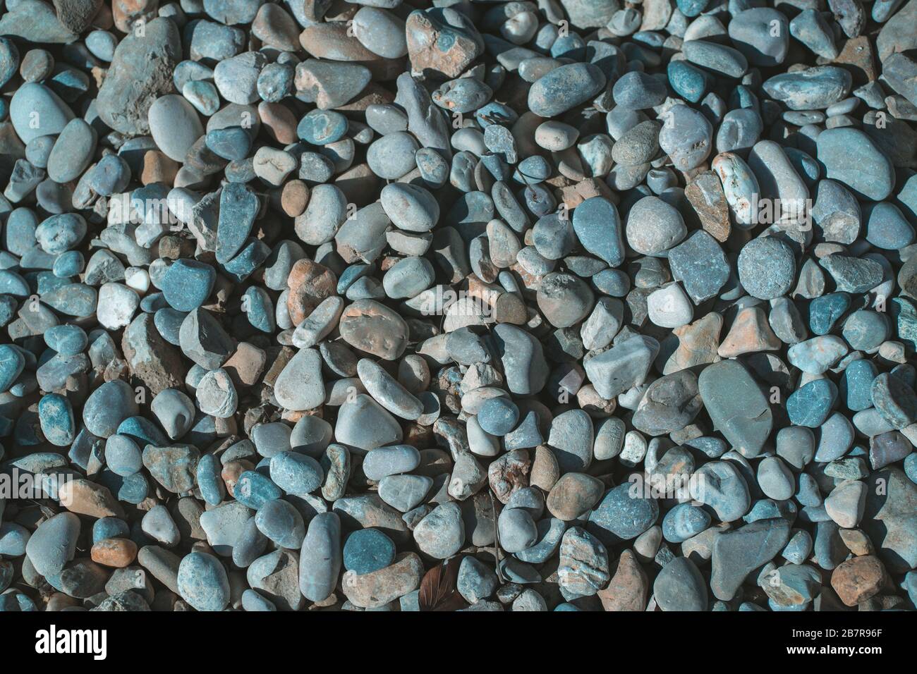 Sea pebbles lie on the ground - background concept Stock Photo - Alamy