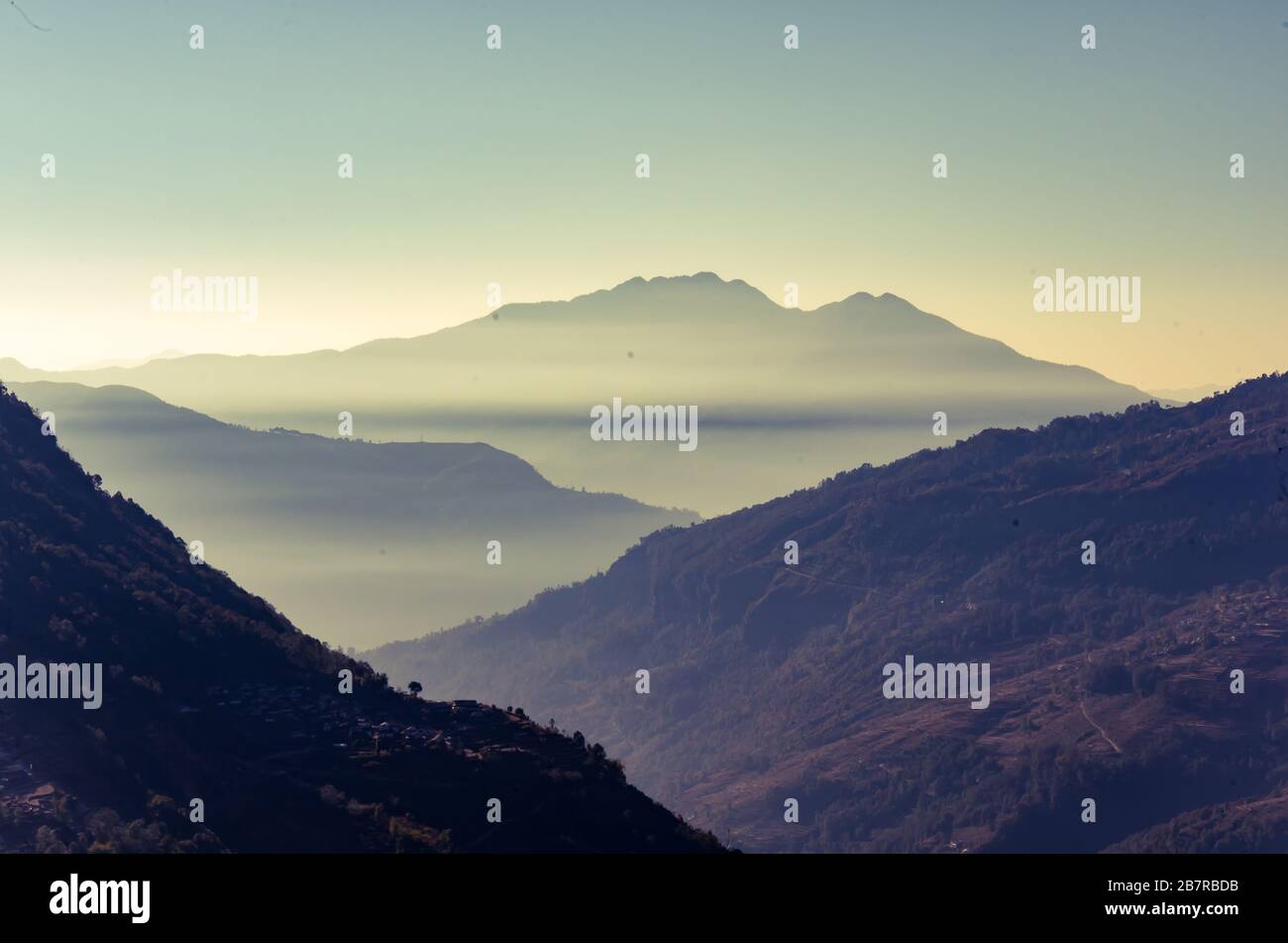 Beautiful early morning landscape of misty mountain ranges Stock Photo ...