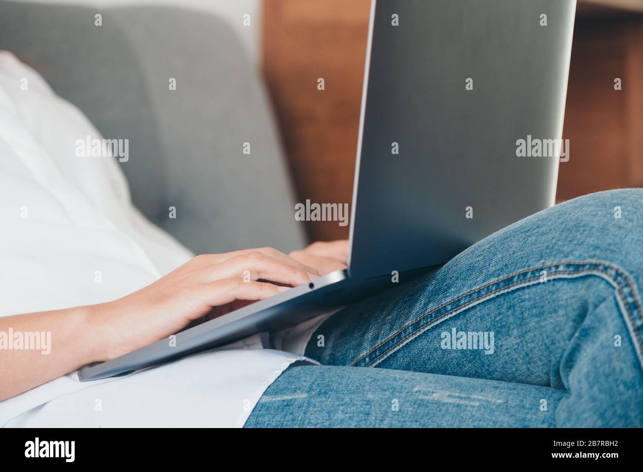 Closeup image of woman using and typing on laptop keyboard while ...