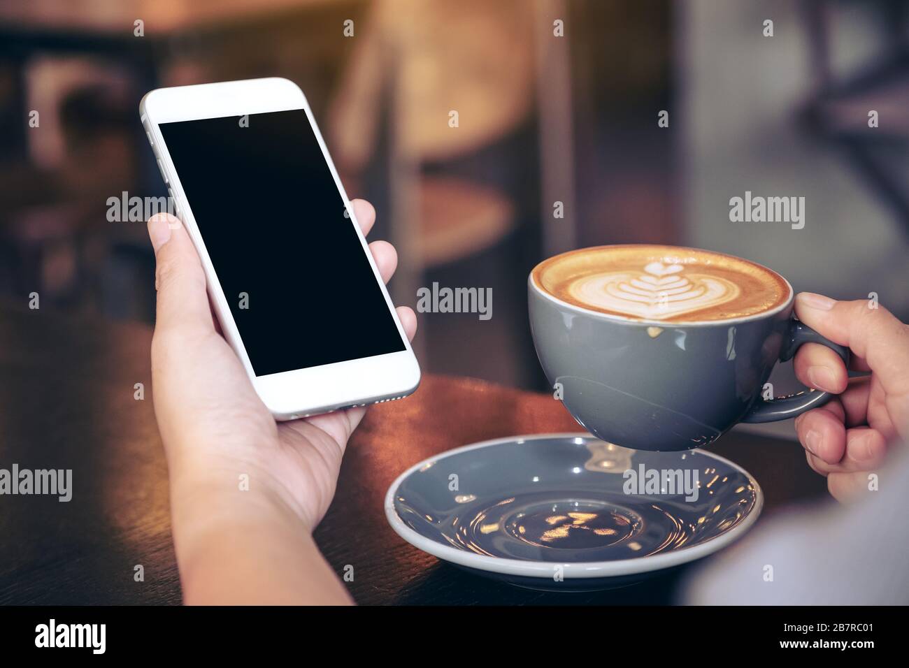 Mockup image of hands holding white mobile phone with blank screen ...