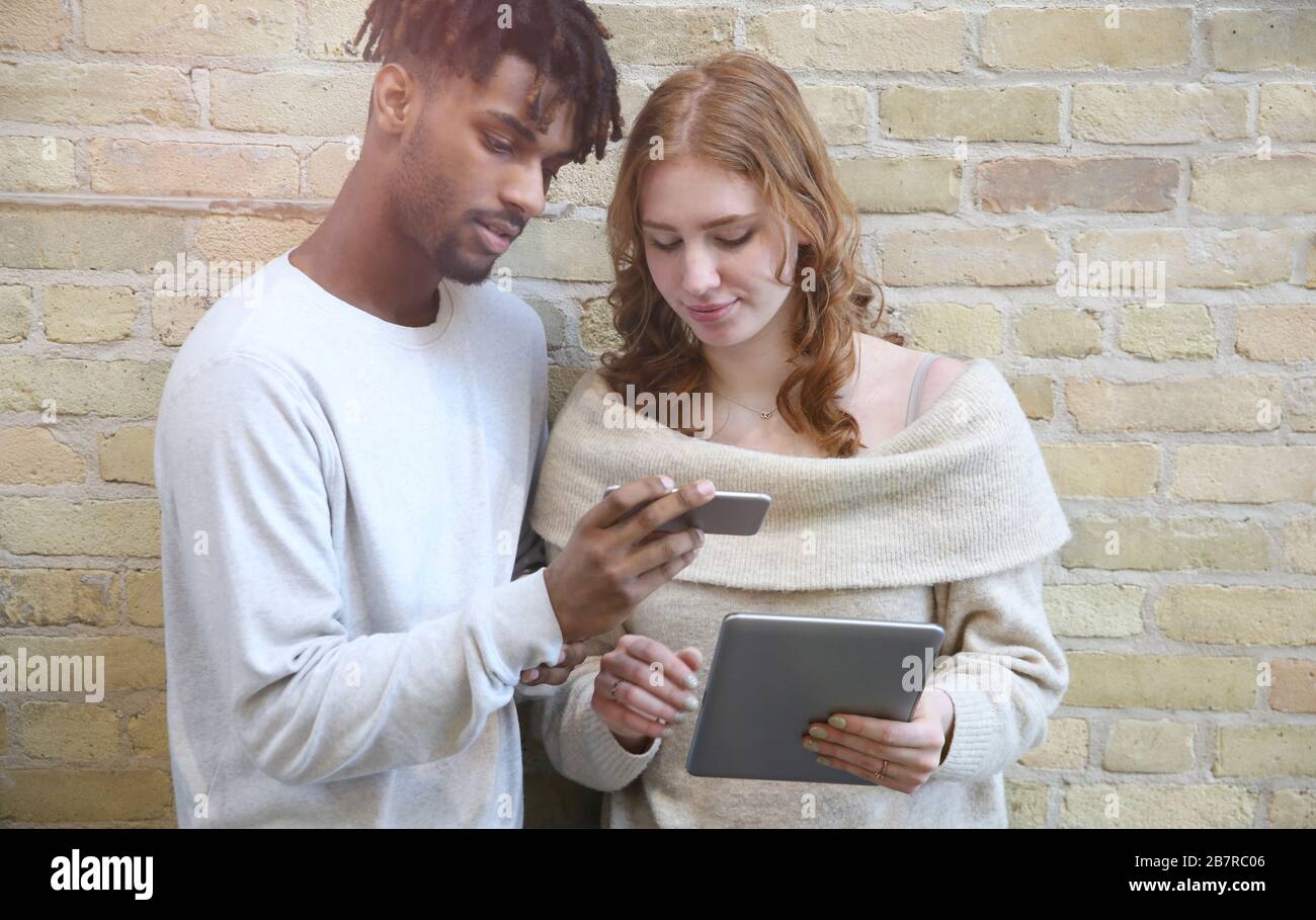 Millenials Laughing and Using Smartphones. Sharing Concept - Diversity ...