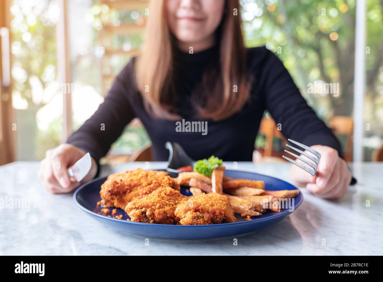 Asian woman eat fried chicken hi-res stock photography and images - Alamy