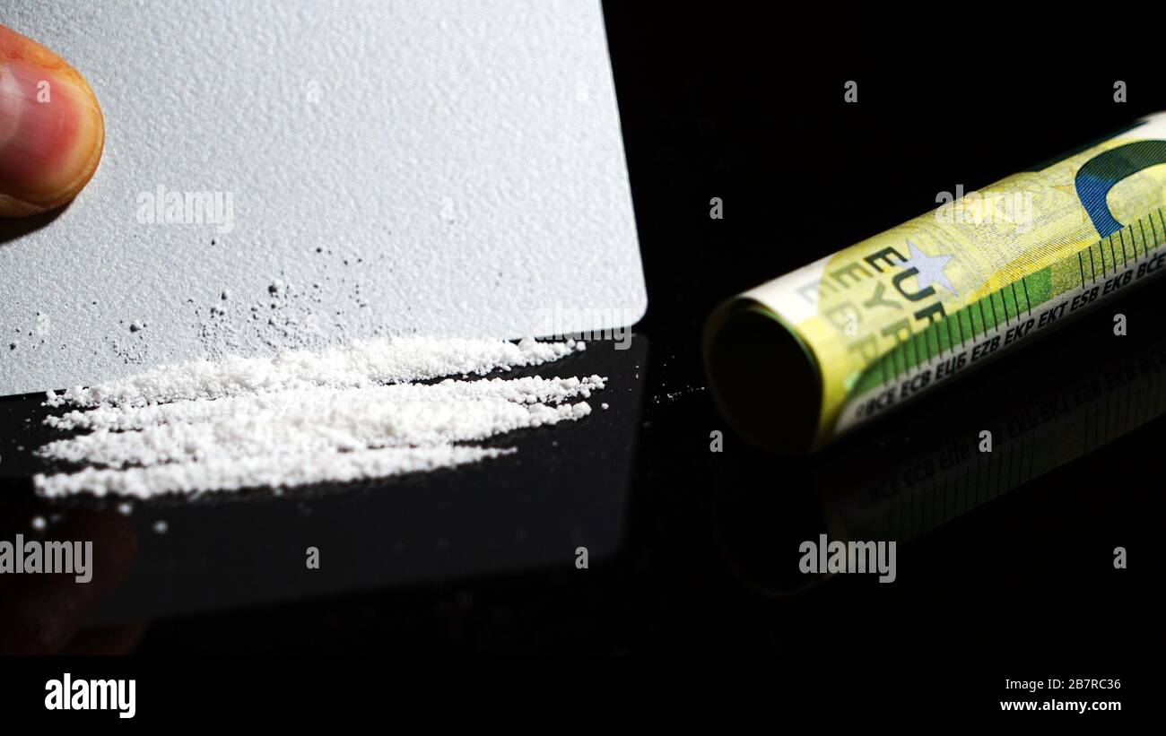 Cocaine lines isolated on black background Stock Photo - Alamy