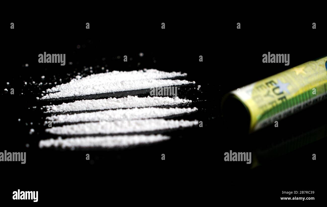 Cocaine lines isolated on black background Stock Photo - Alamy