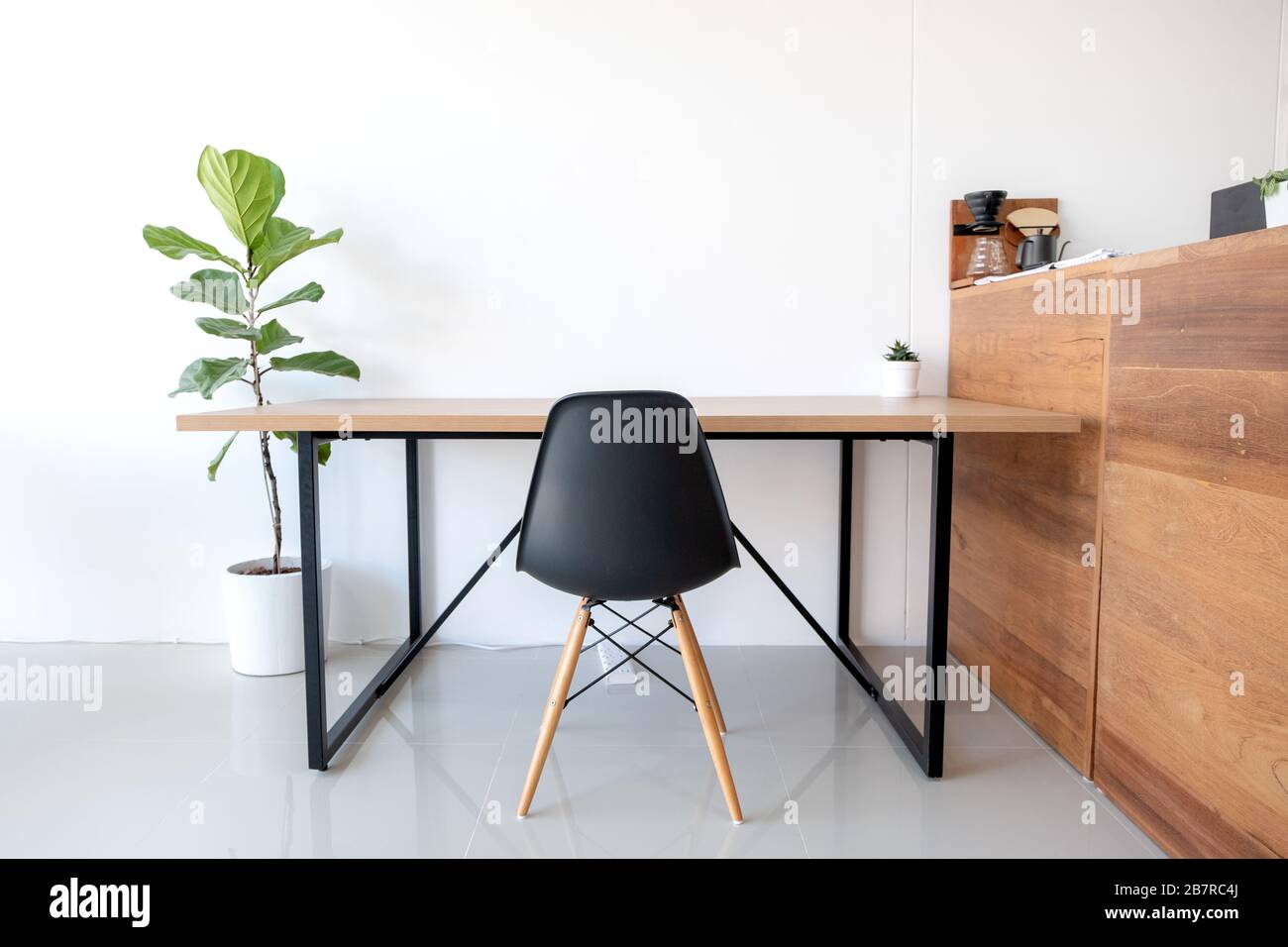 Wooden tables and chairs with trees decorative in white modern office ...
