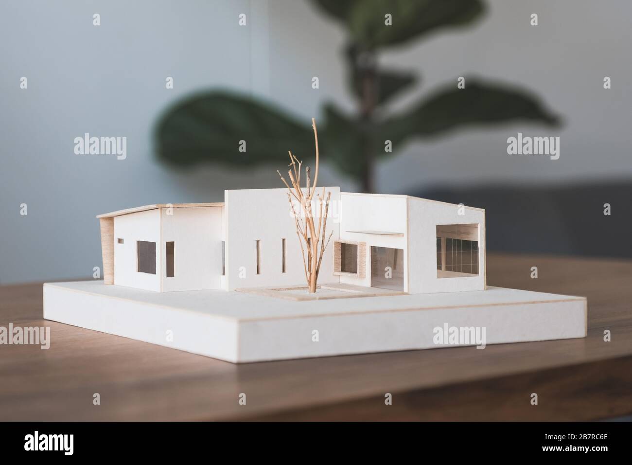 An architecture model on wooden table in office with blur nature ...