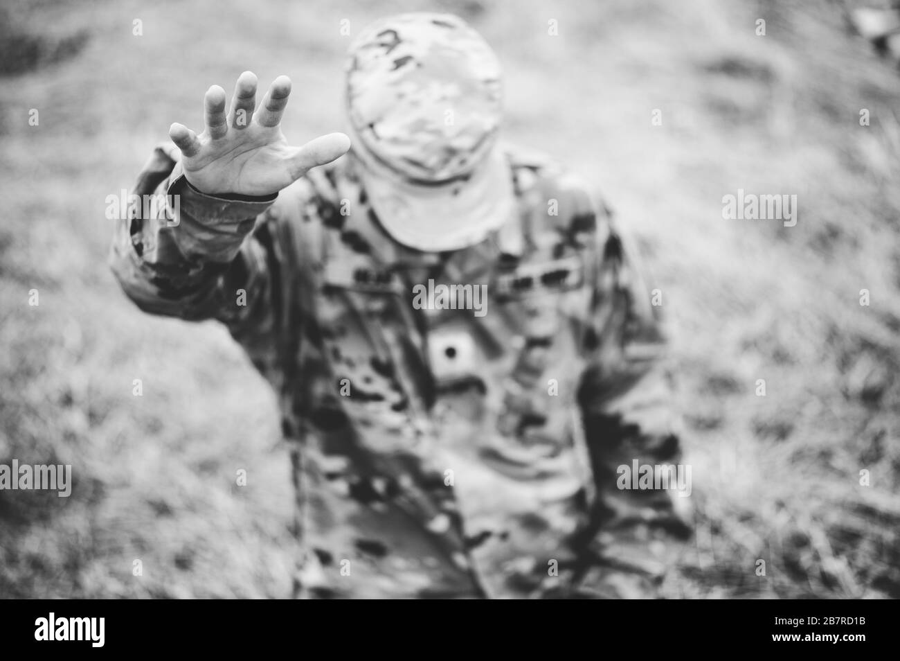 Grayscale shot of an American soldier with his hand raised above Stock ...