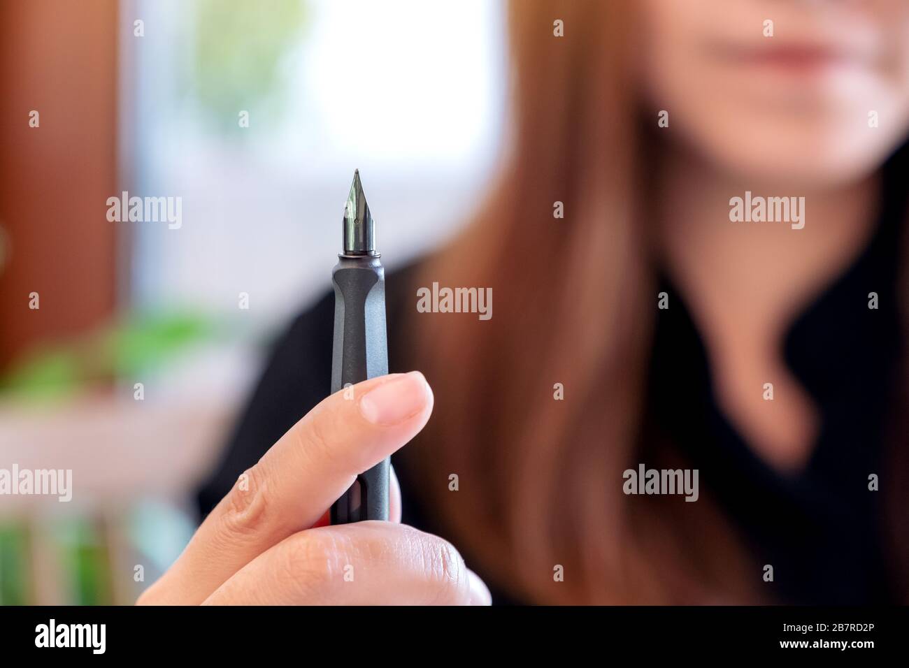 Woman holding fountain pen hi-res stock photography and images - Alamy
