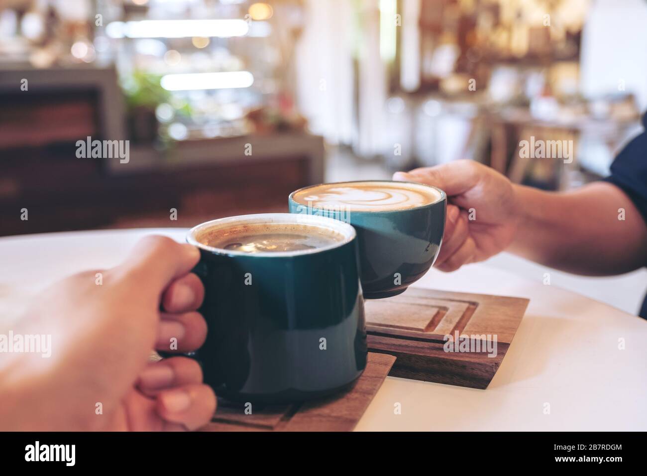 Mugs clinking hi-res stock photography and images - Alamy