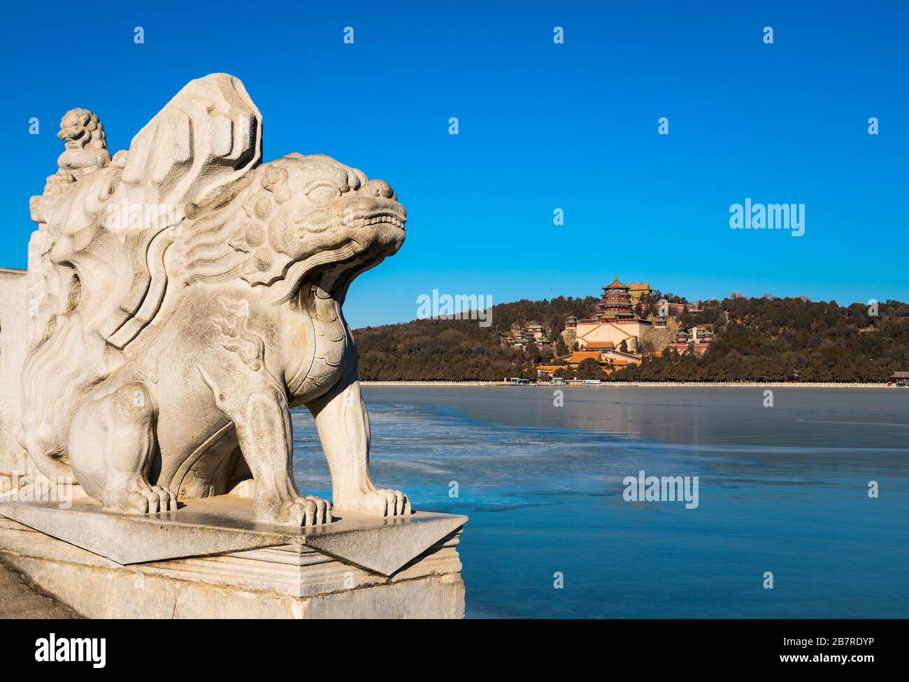 Stone lions on a bridge with palace at distance in Summary palace ...