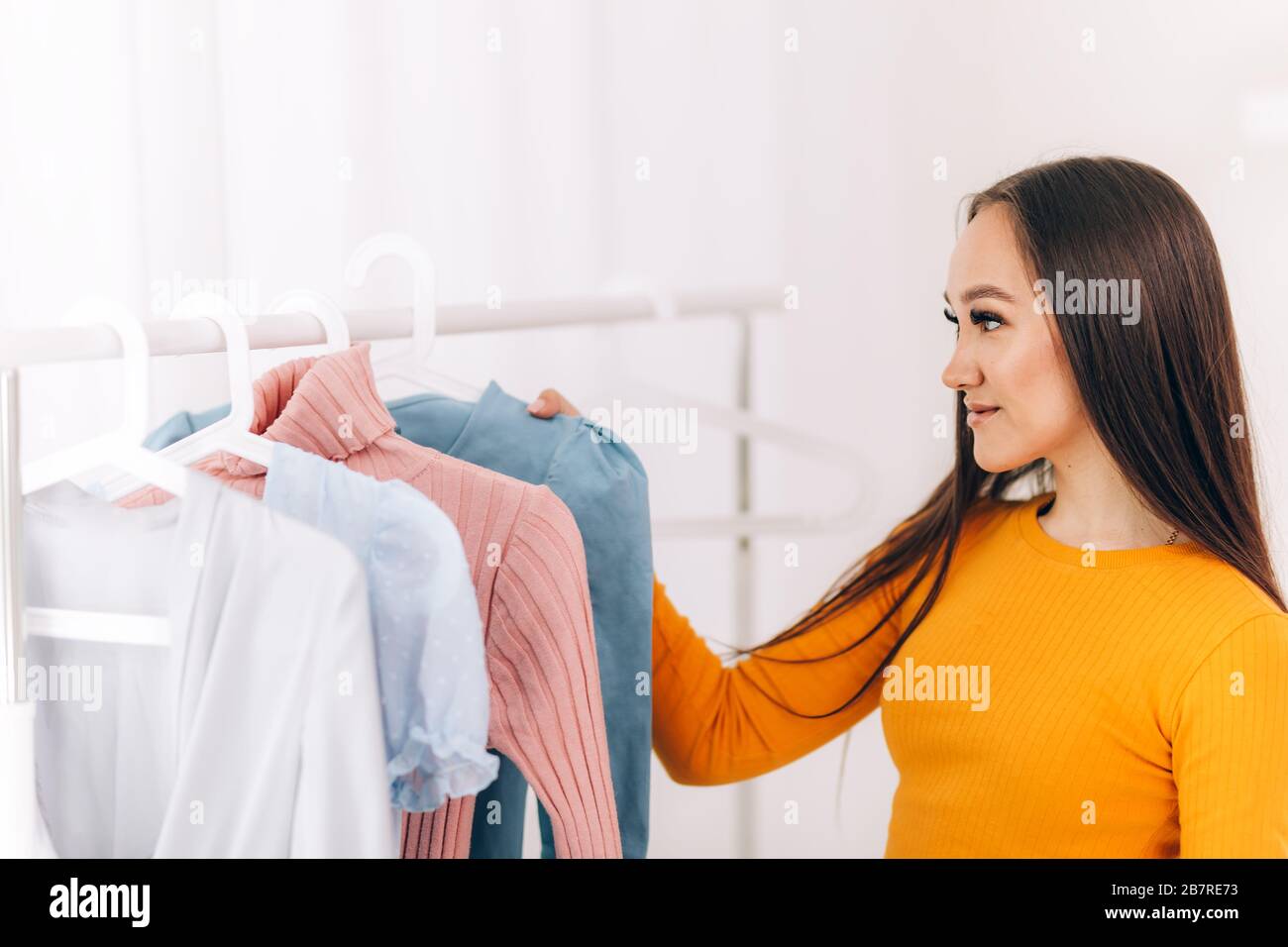 Girl chooses clothes Stock Photo - Alamy