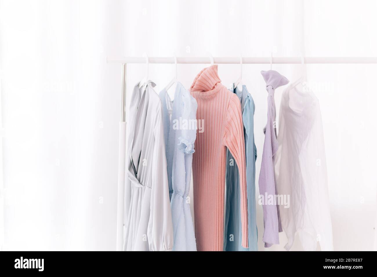 clothes hanging on hangers Stock Photo - Alamy