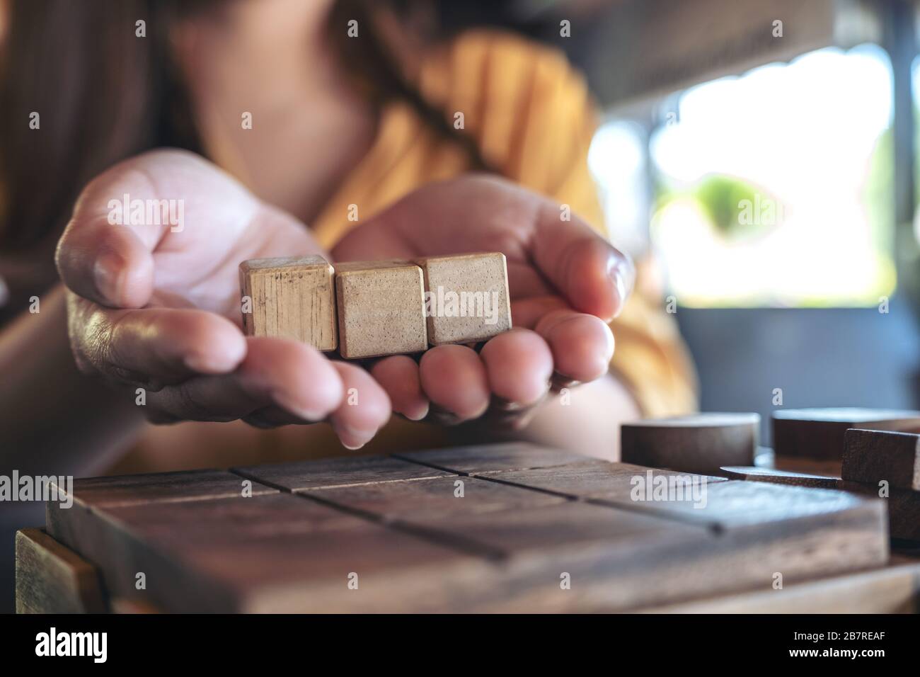 Female hands wooden cubes hi-res stock photography and images - Alamy