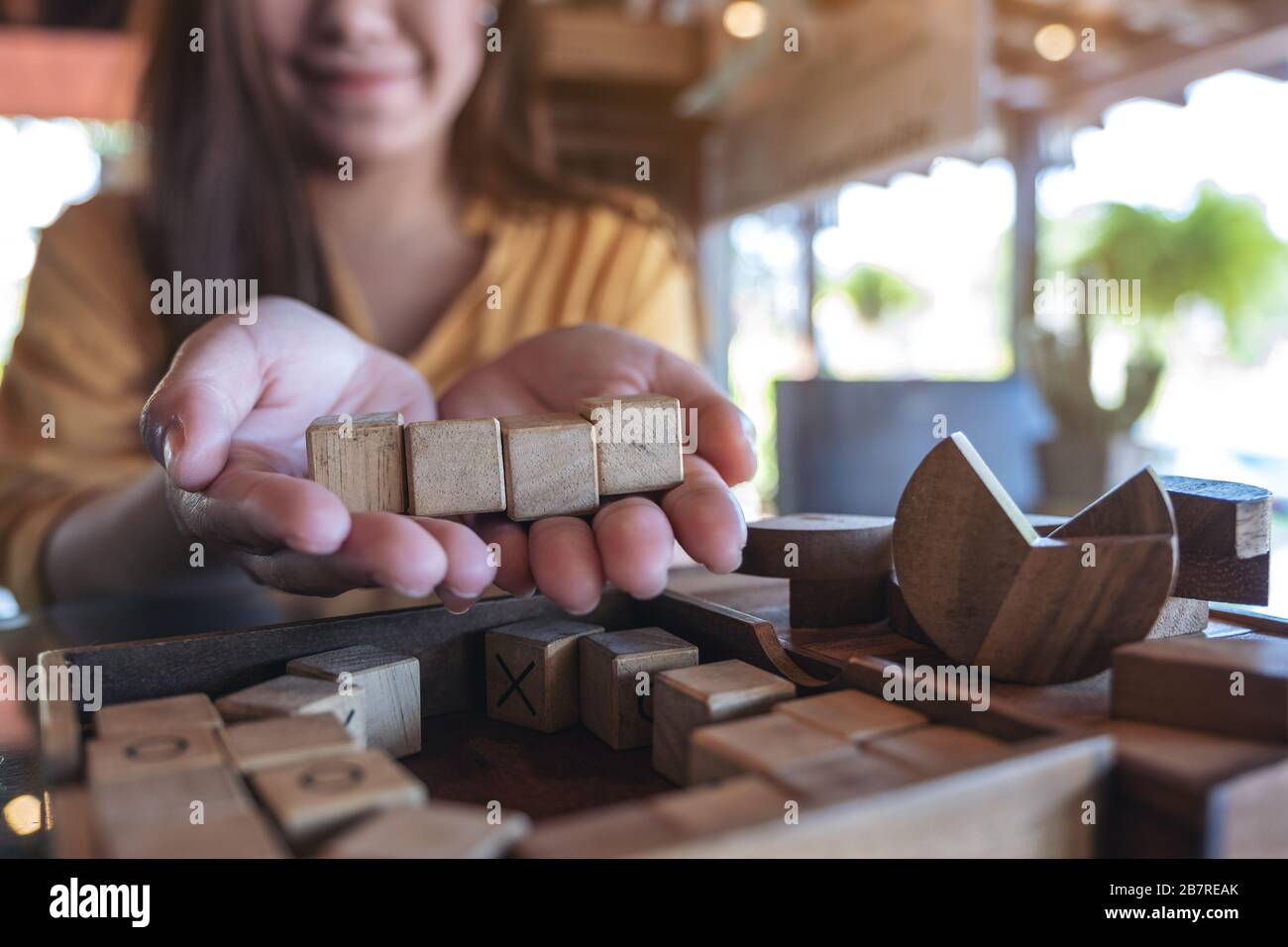 Woman stacking wooden block hi-res stock photography and images - Alamy